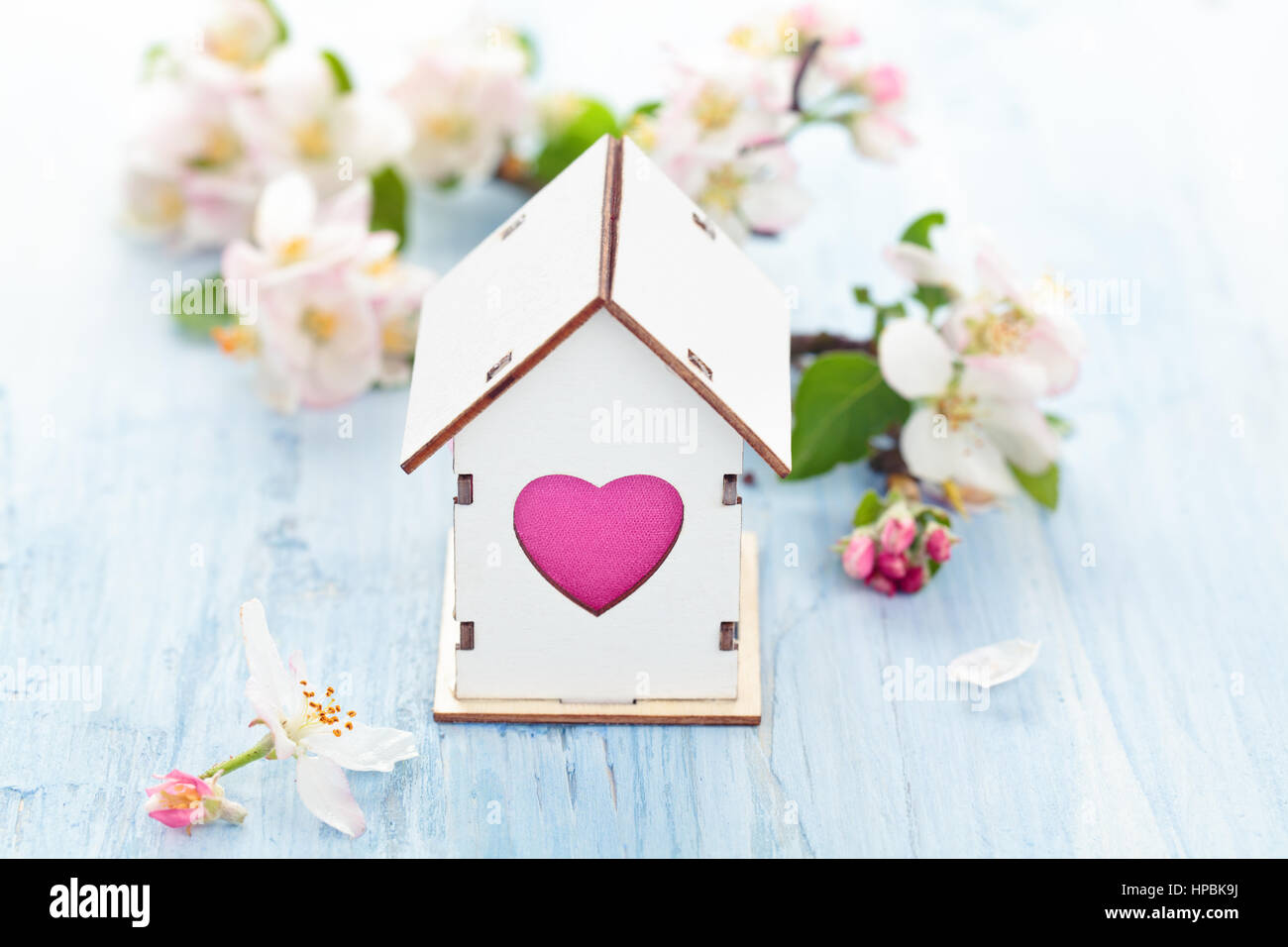 White Wood houses with colorful heart shaped windows Stock Photo - Alamy