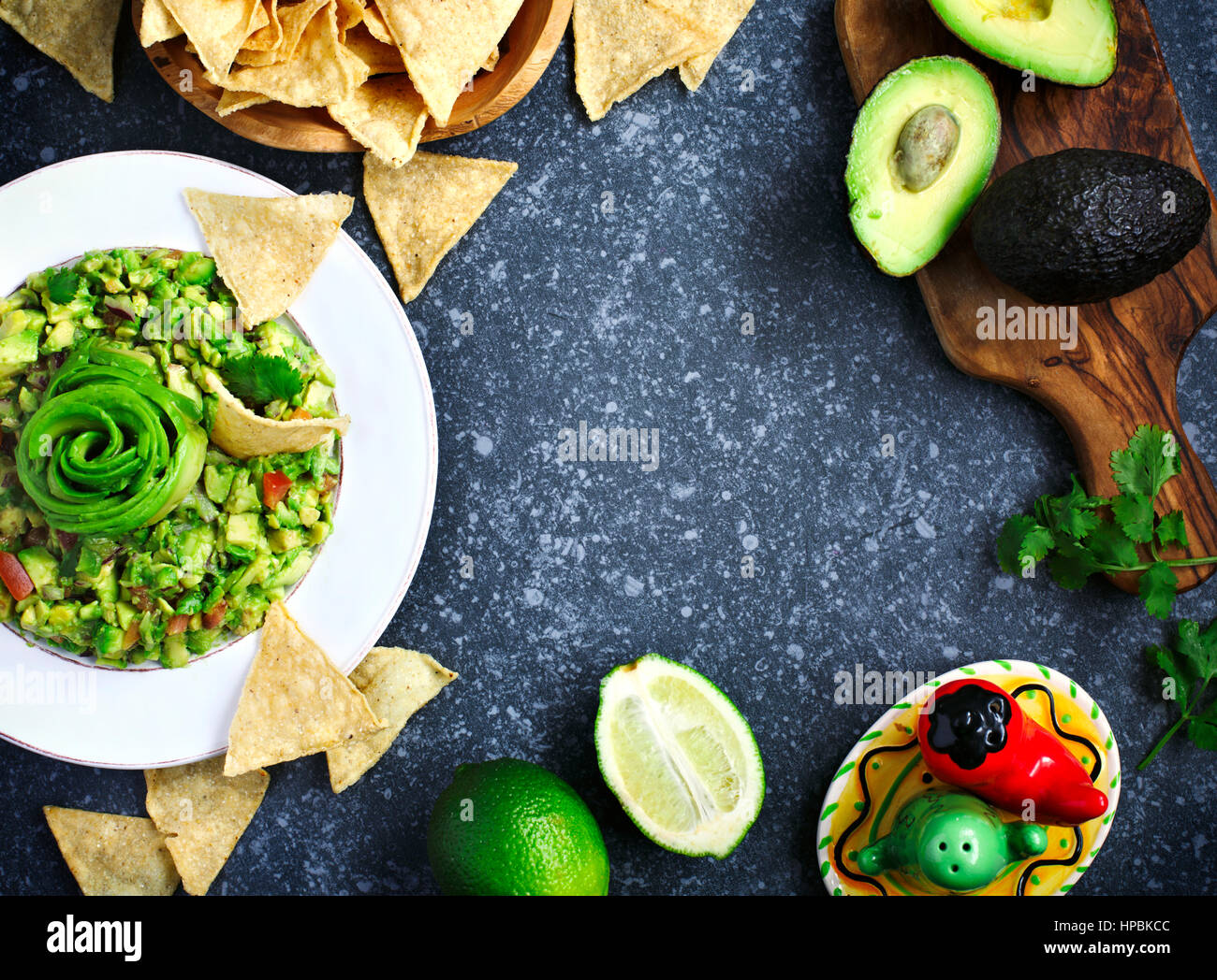 Traditional mexican sauce guacamole with fresh ingredients on stone ...