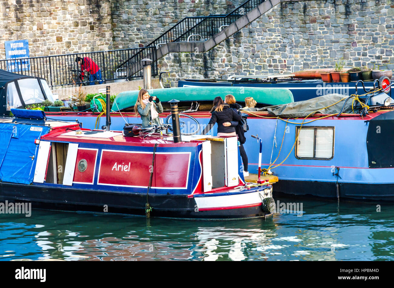 A group of friends take a photograph on a pontoon in-between two ...