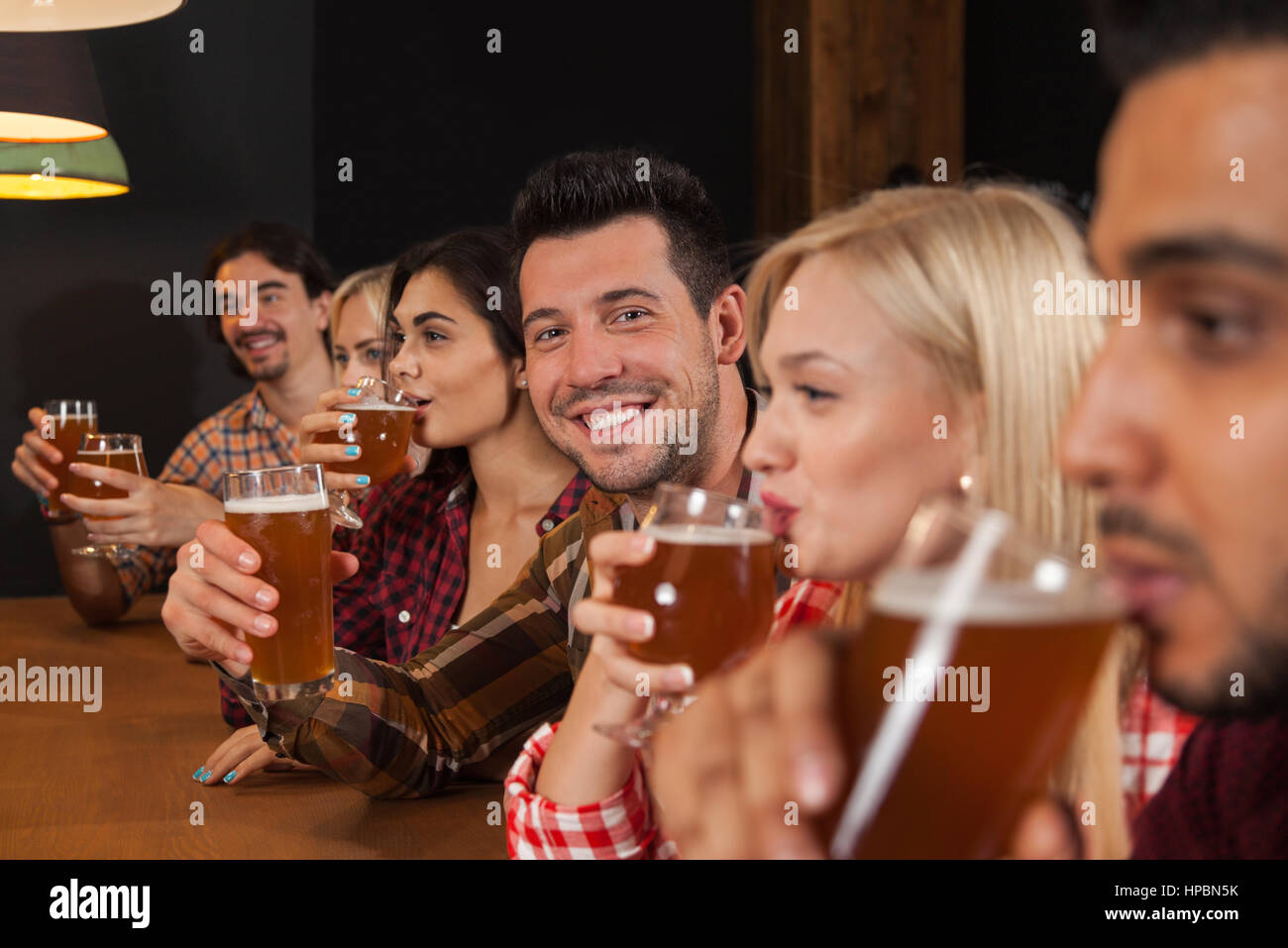 Young People Group In Bar, Friends Sitting At Wooden Counter Pub, Drink ...