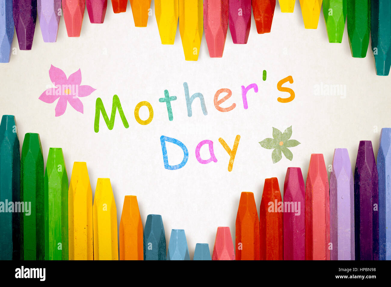 Row of colorful crayon with mothers day message over stripe pattern ...