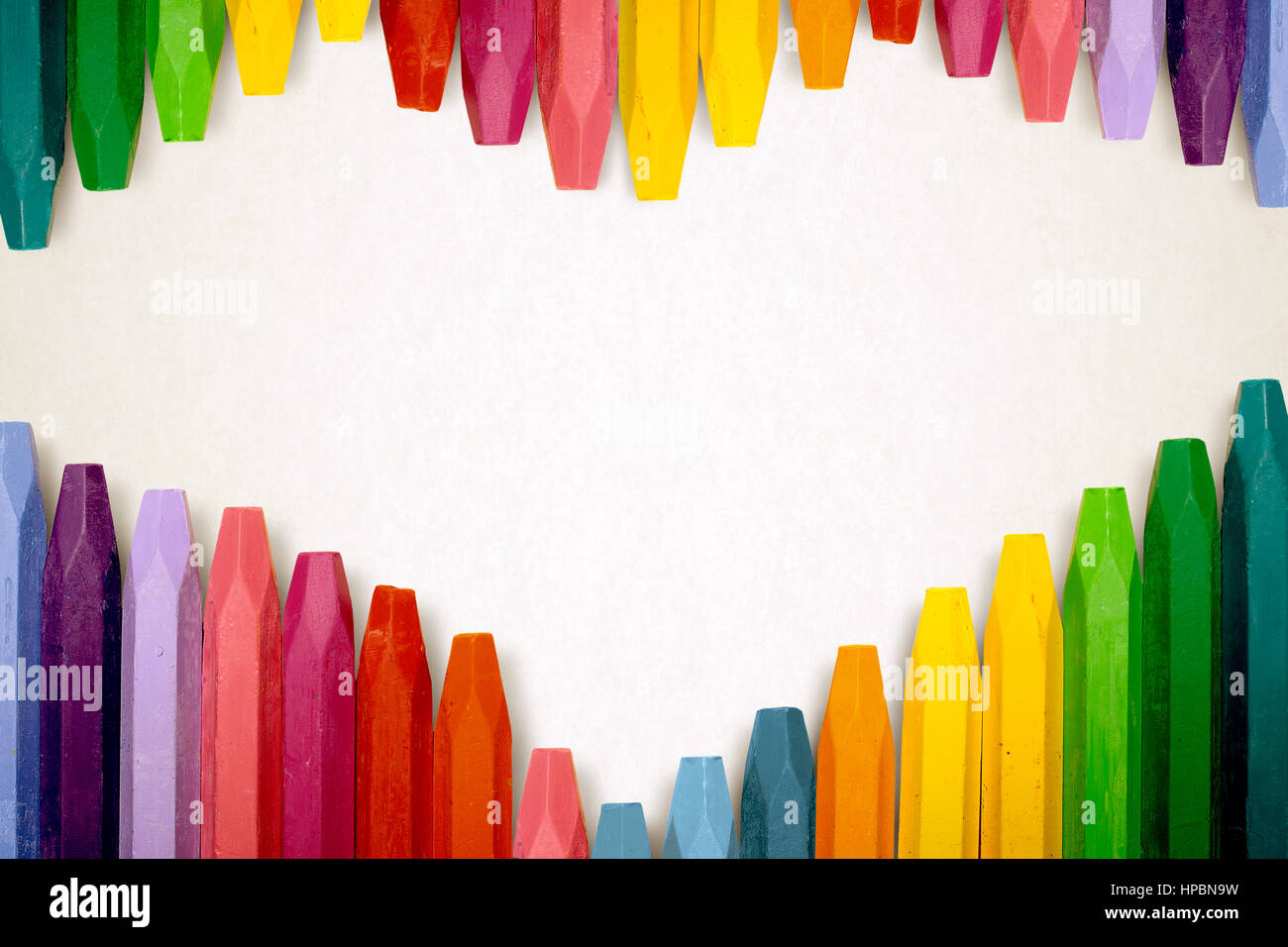 Row of colorful crayon over stripe pattern paper for copyspace Stock ...