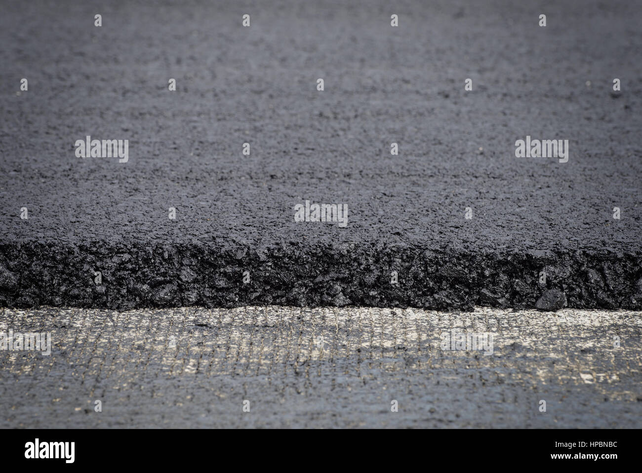closeup black asphalt road details, construction concept background ...