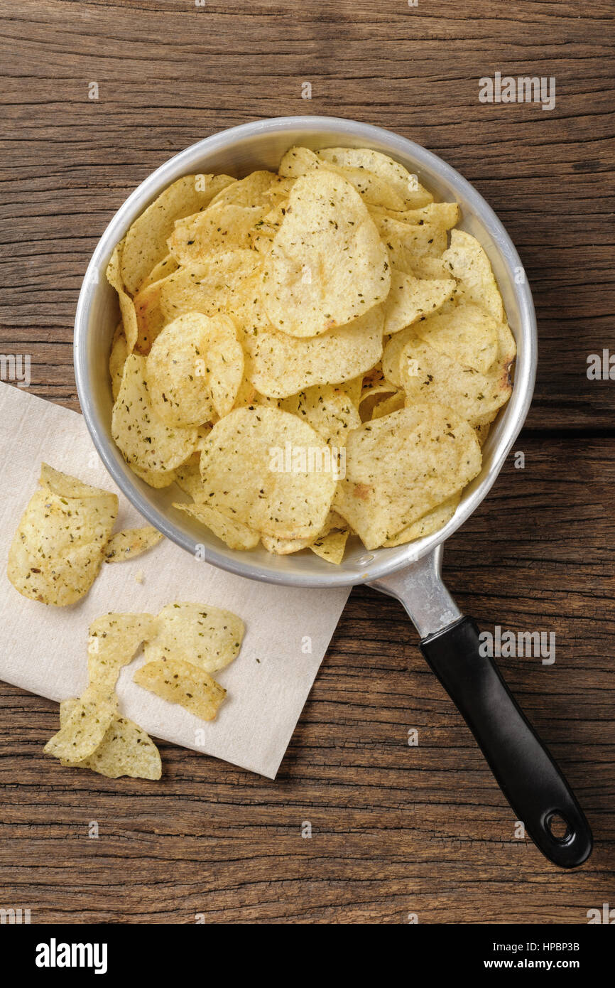 closeup potato chips in pan on wooden desk Stock Photo - Alamy
