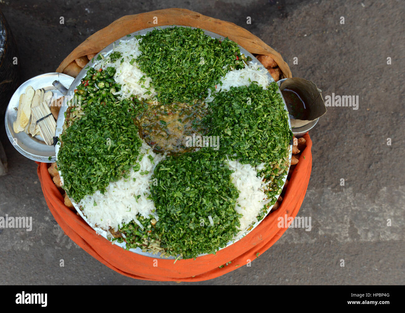 A street food vendor in Lucknow, India serving boiled chickpeas with ...