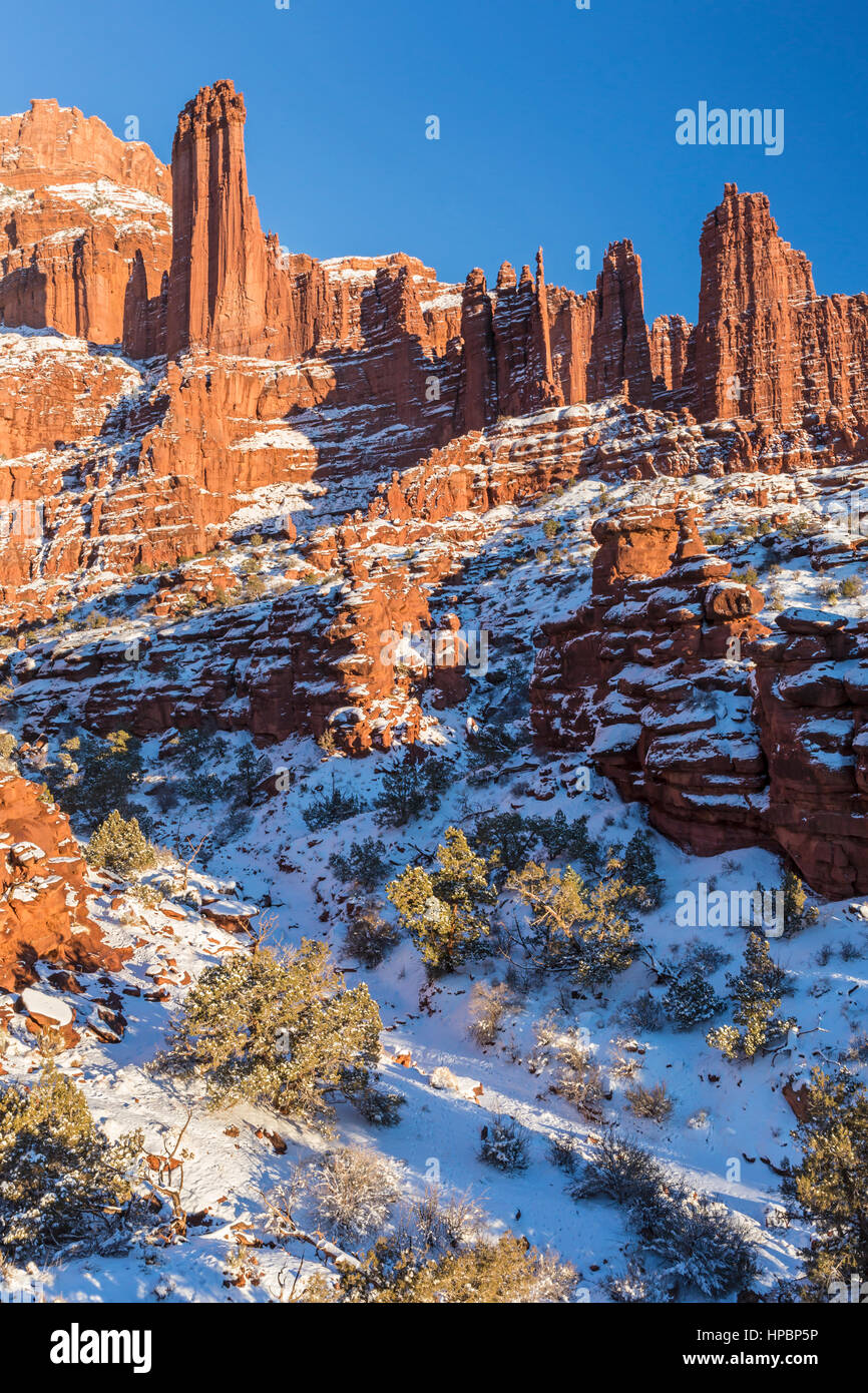 Rock fins rise above the a snowy canyon at the Fisher Towers rock ...