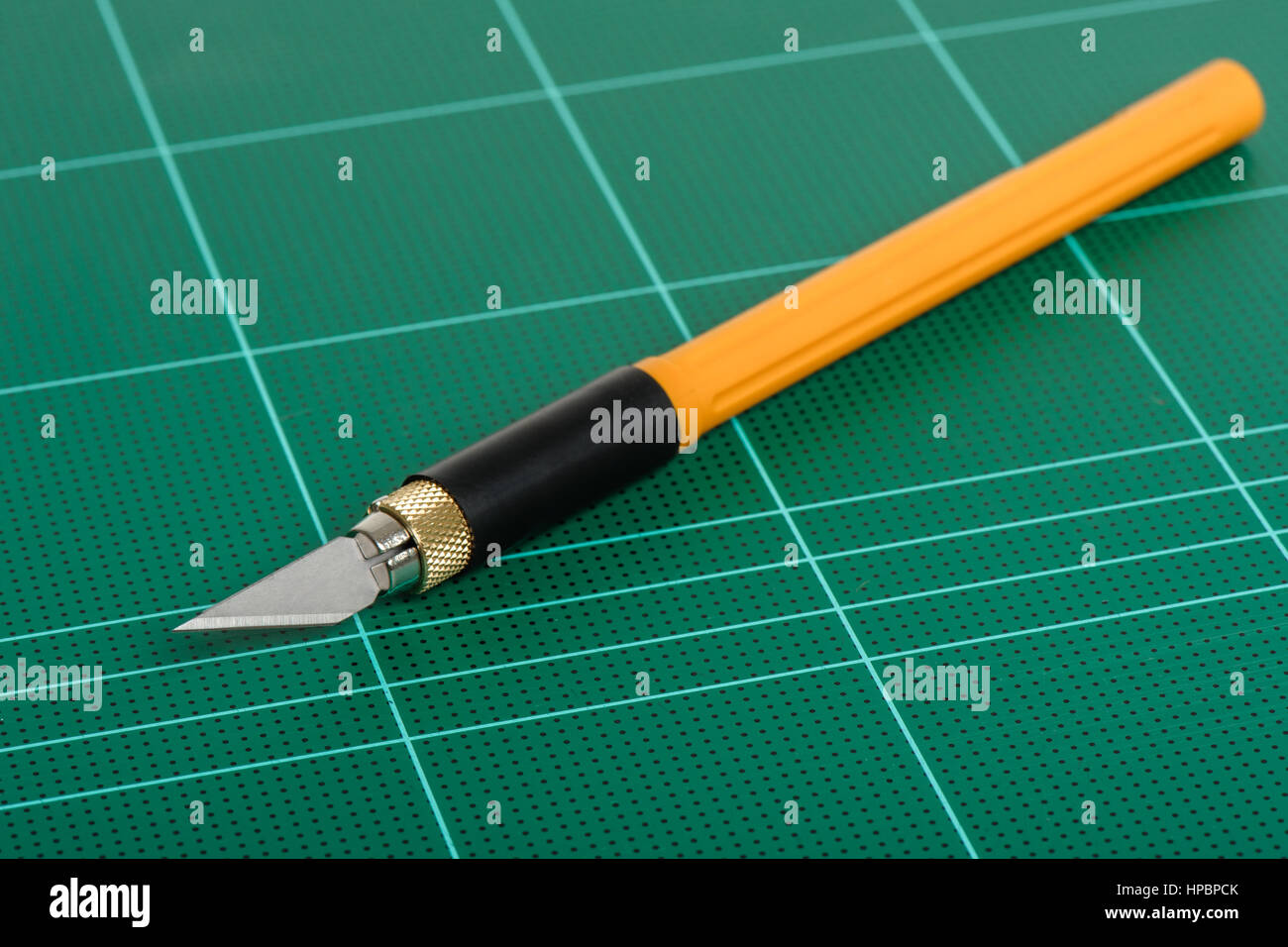closeup craft knife isolated on cutting mat, stationery Stock Photo - Alamy