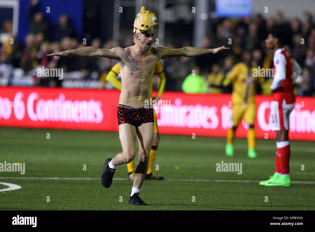 Sutton, UK. 20th Feb, 2017. The game is halted for a pitch invader ...