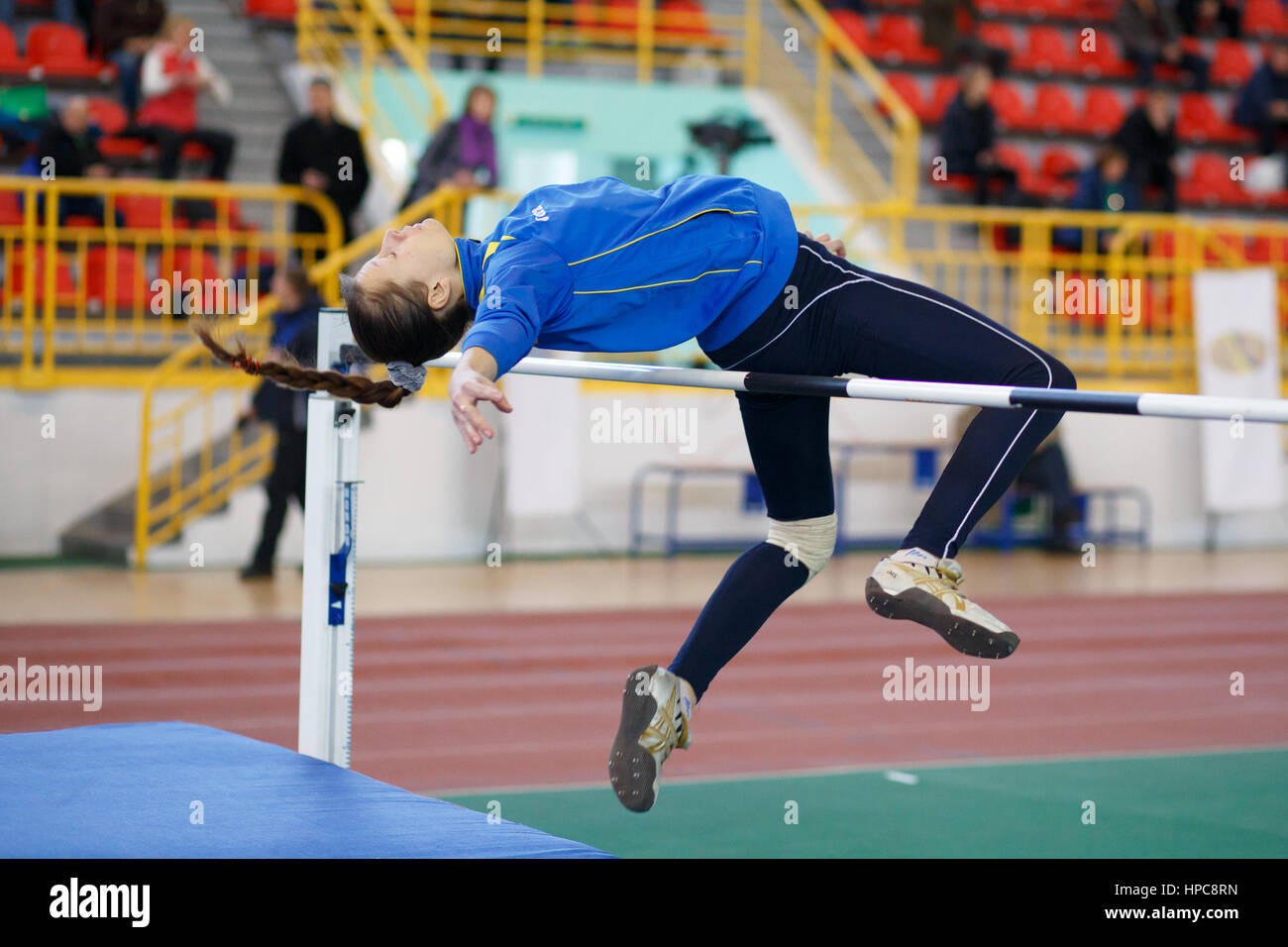 Athlete high jumping in arena hi-res stock photography and images - Alamy