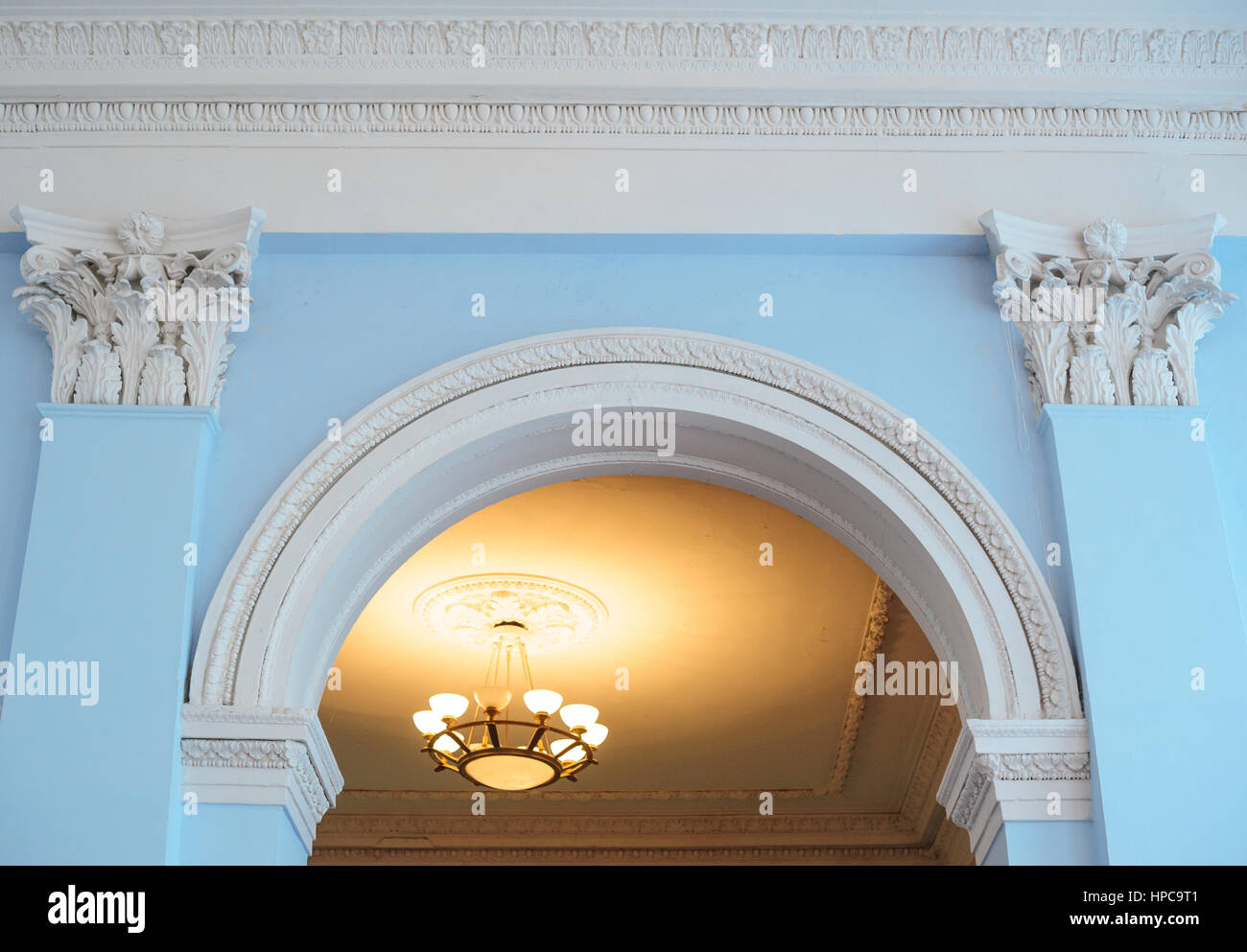white arch on a blue wall inside the building Stock Photo - Alamy
