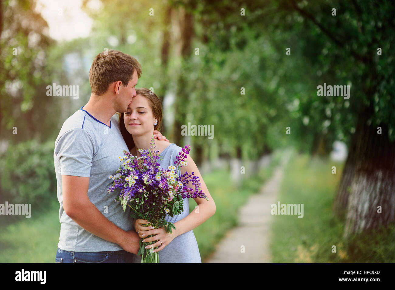 young couple in love with a bouquet of flowers on a background of the ...