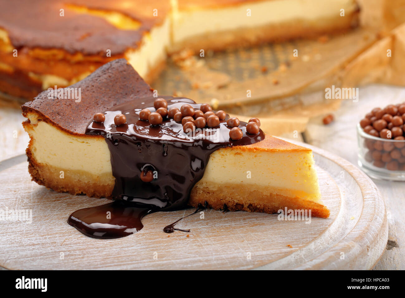 Cheesecake slice with melted chocolate and chocolate balls Stock Photo ...