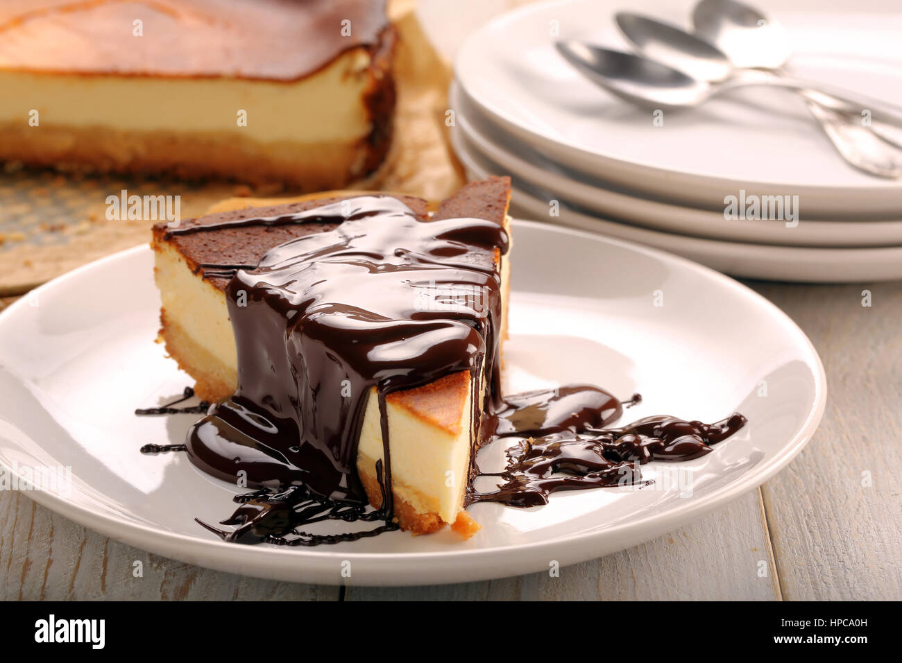 Cheesecake slice with melted chocolate Stock Photo - Alamy