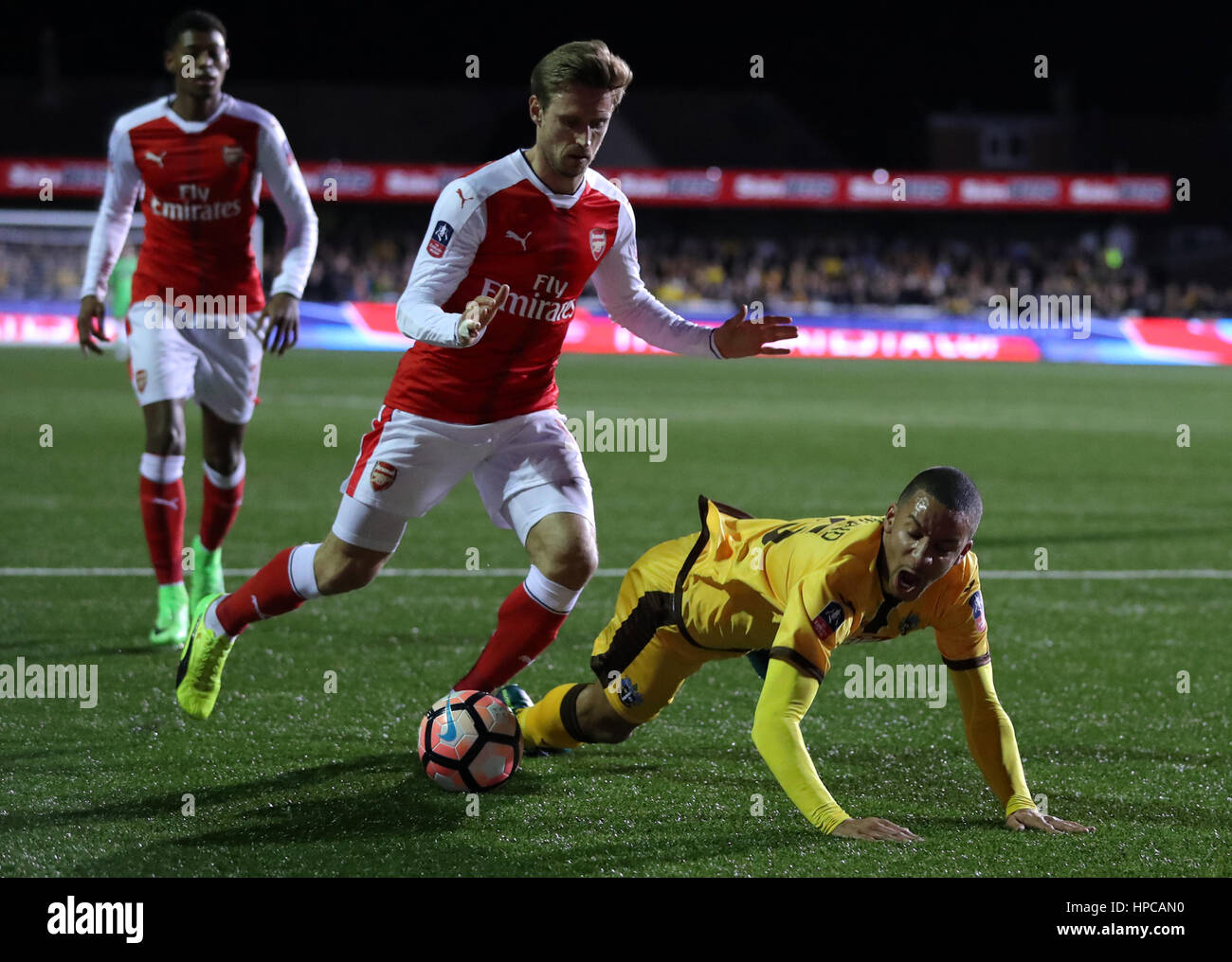 Sutton's Craig Eastmond goes down under a challenge in the box from ...