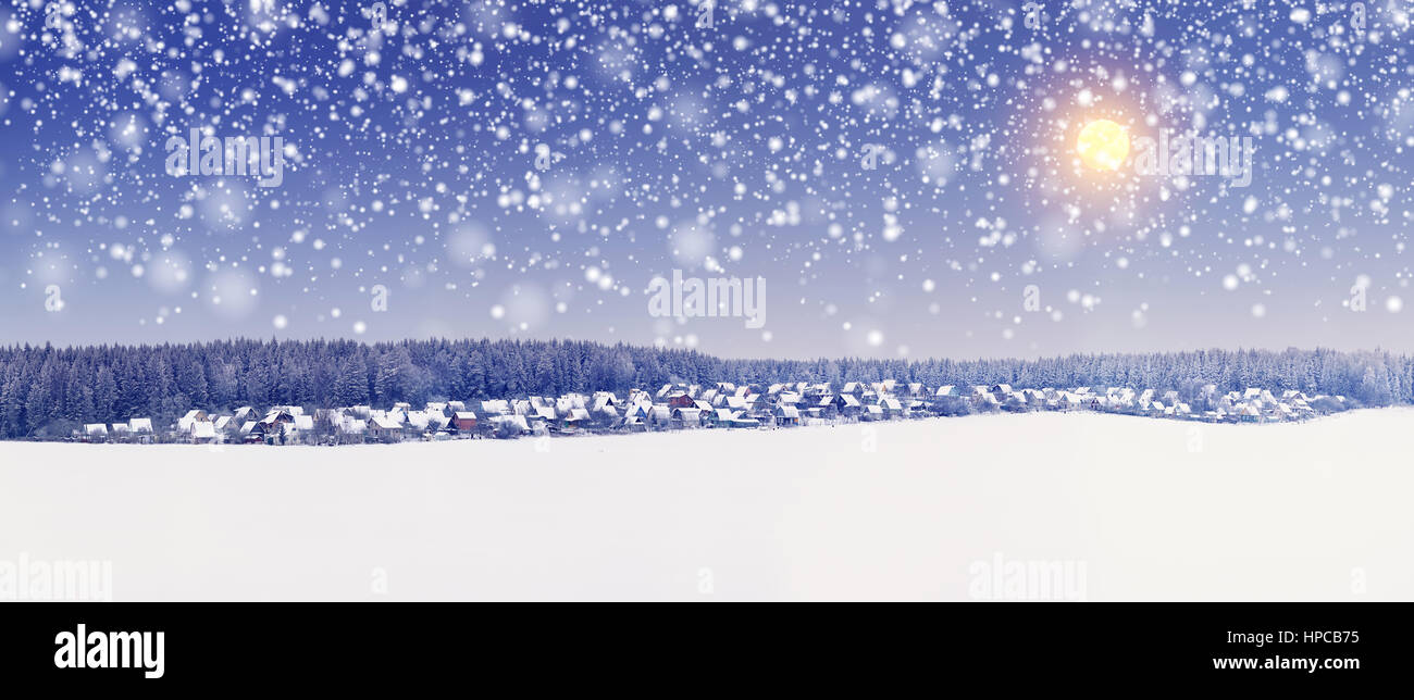 Christmas night with full moon in blue sky. Snowfall at snowy night ...