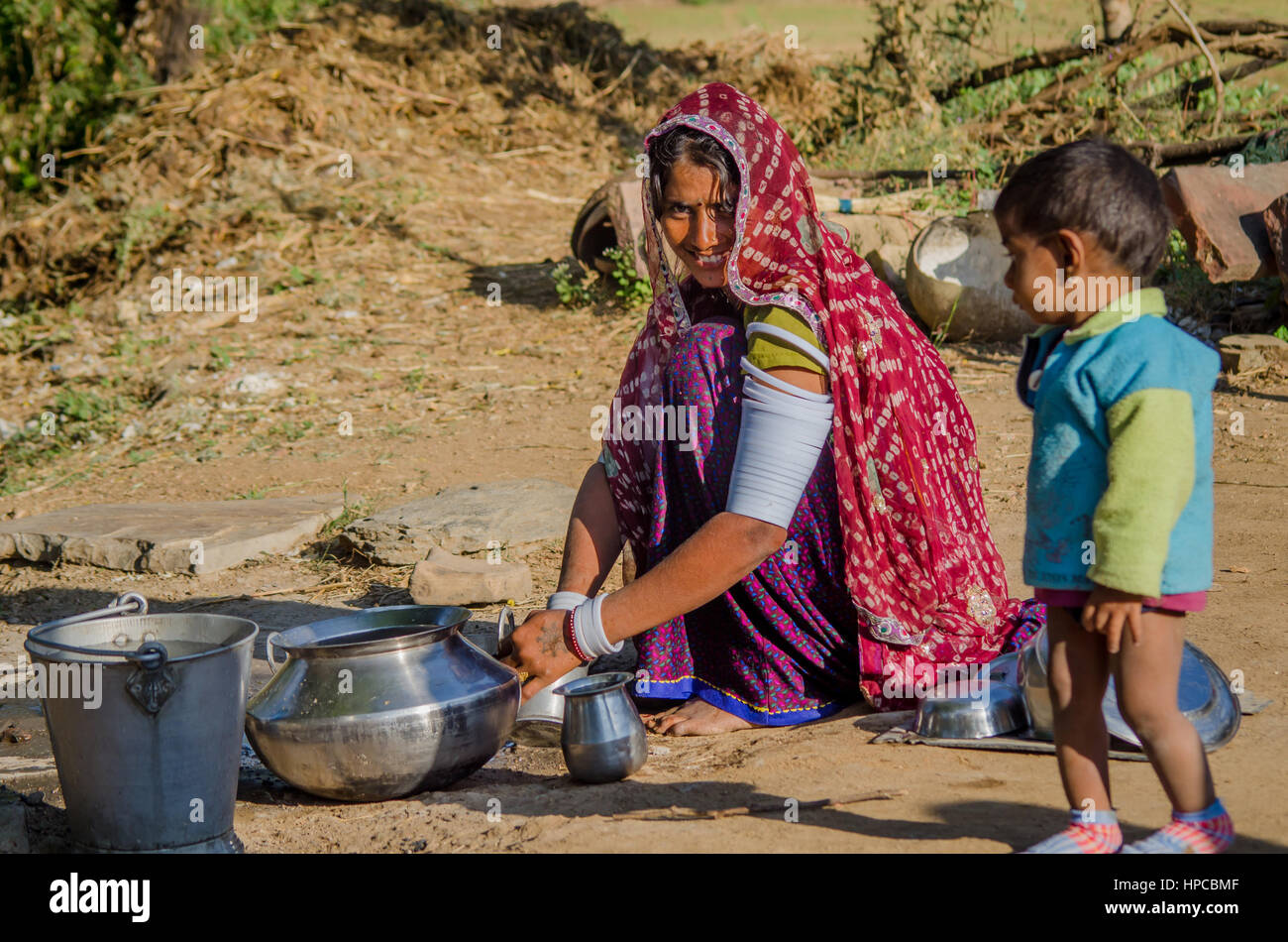 RAJASTHAN, INDIA - NOVEMBER 20, 2016: Rajasthani poor woman cleaning ...