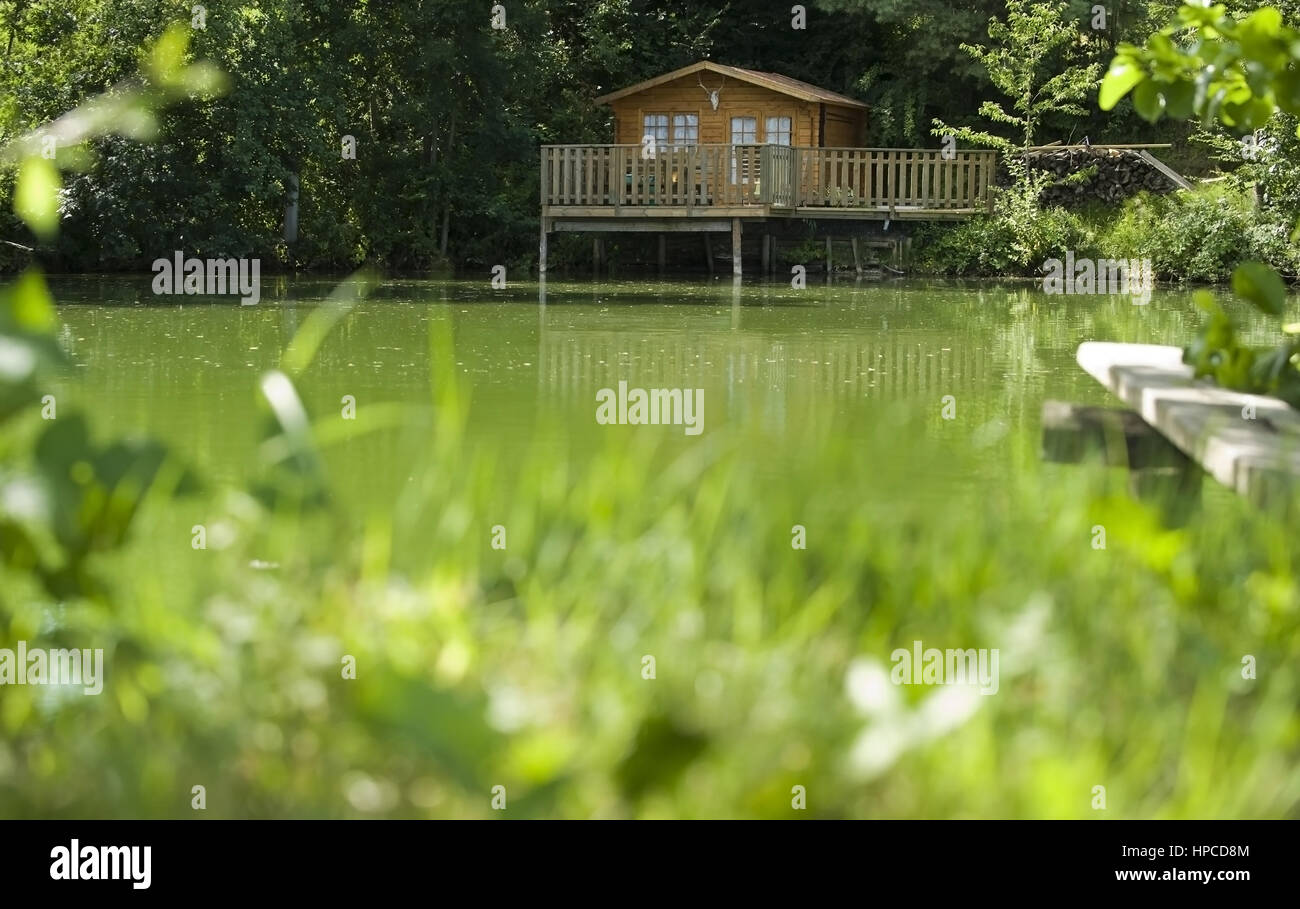 Holzhuette am Teich - wood house at pondside Stock Photo - Alamy