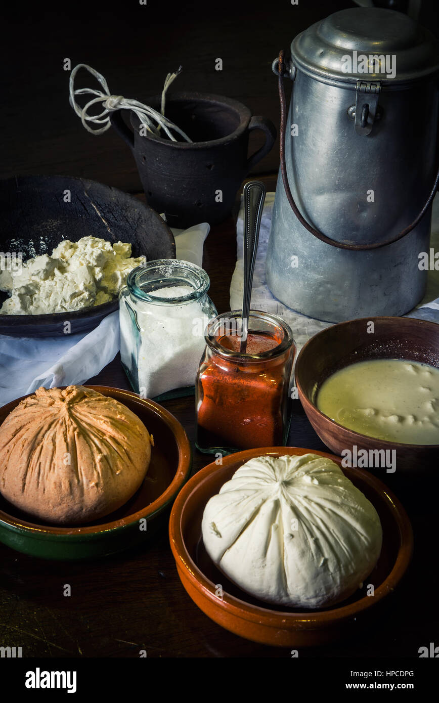 home made cheese over a rustic wooden table with its ingredients, milk ...