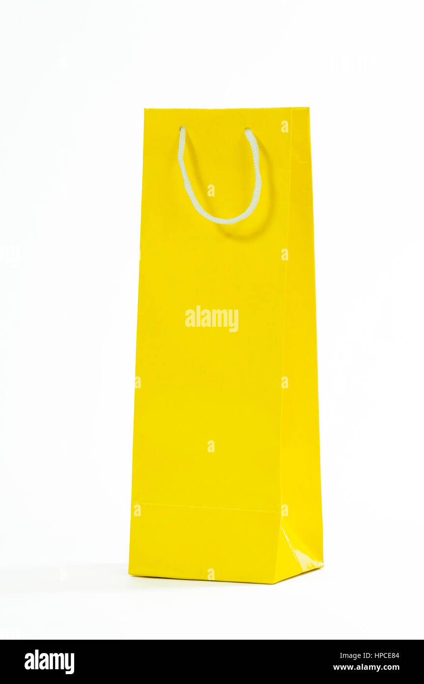 Yellow paper bag, isolated on white background Stock Photo - Alamy
