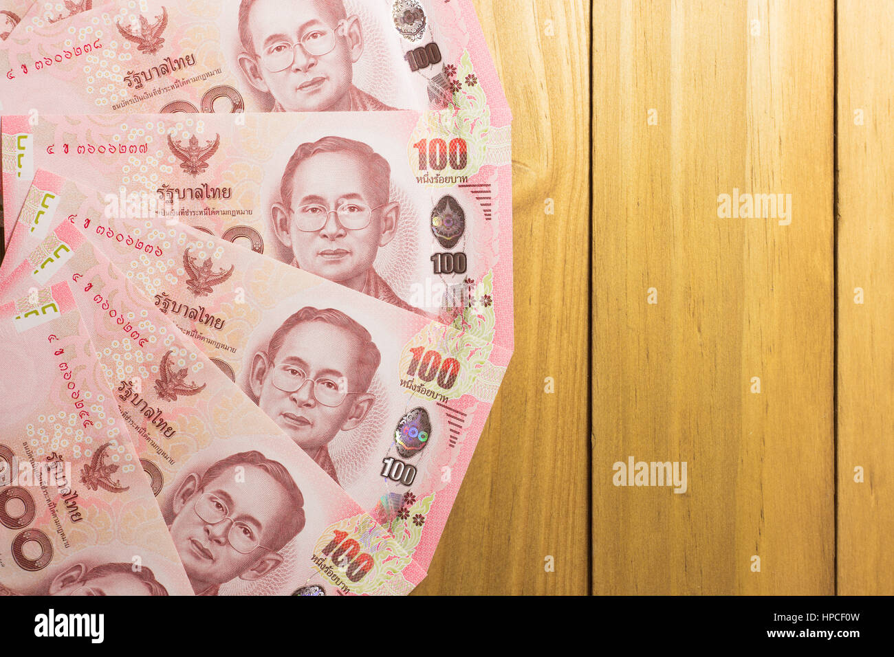 Thai banknotes money on wood background Stock Photo - Alamy