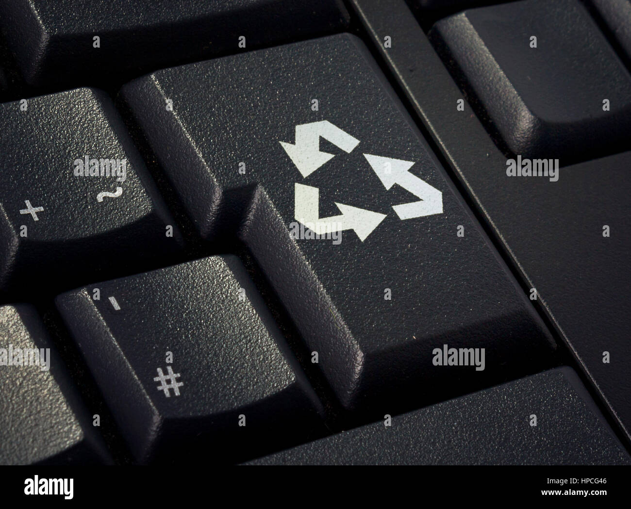 Return key of a black keyboard with the shape of arrows of recycling ...