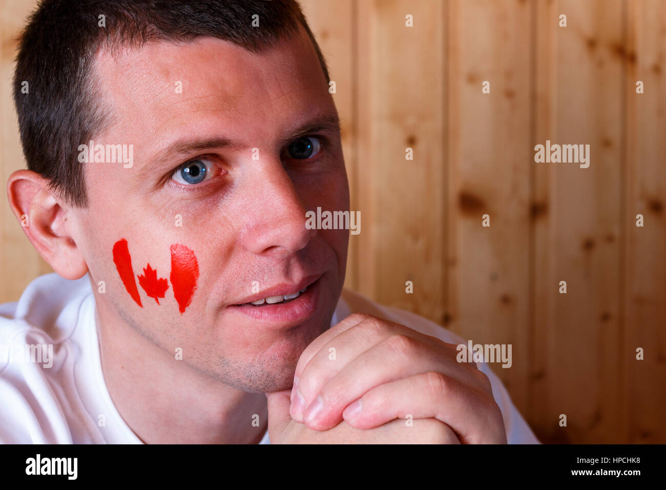 canadian flag on the face of young man Stock Photo - Alamy