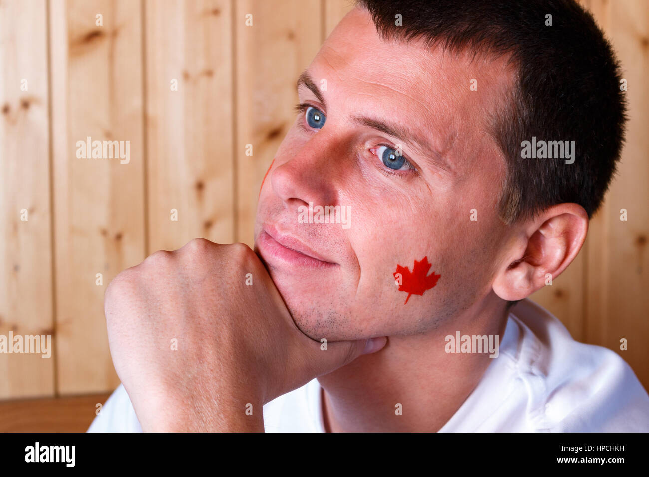 canadian flag on the face of young man Stock Photo - Alamy