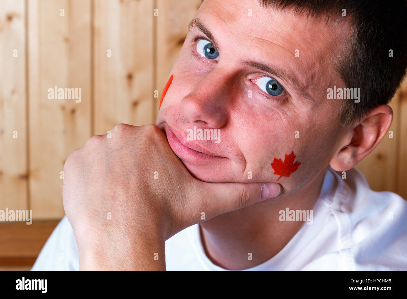 canadian flag on the face of young man Stock Photo - Alamy