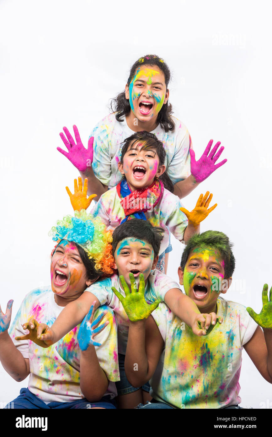 five or 5 cute little indian kids playing with colours or asian ...