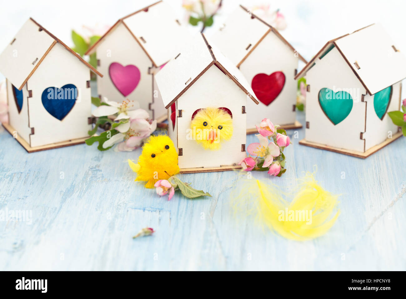 White Wood houses with colorful heart shaped windows Stock Photo - Alamy