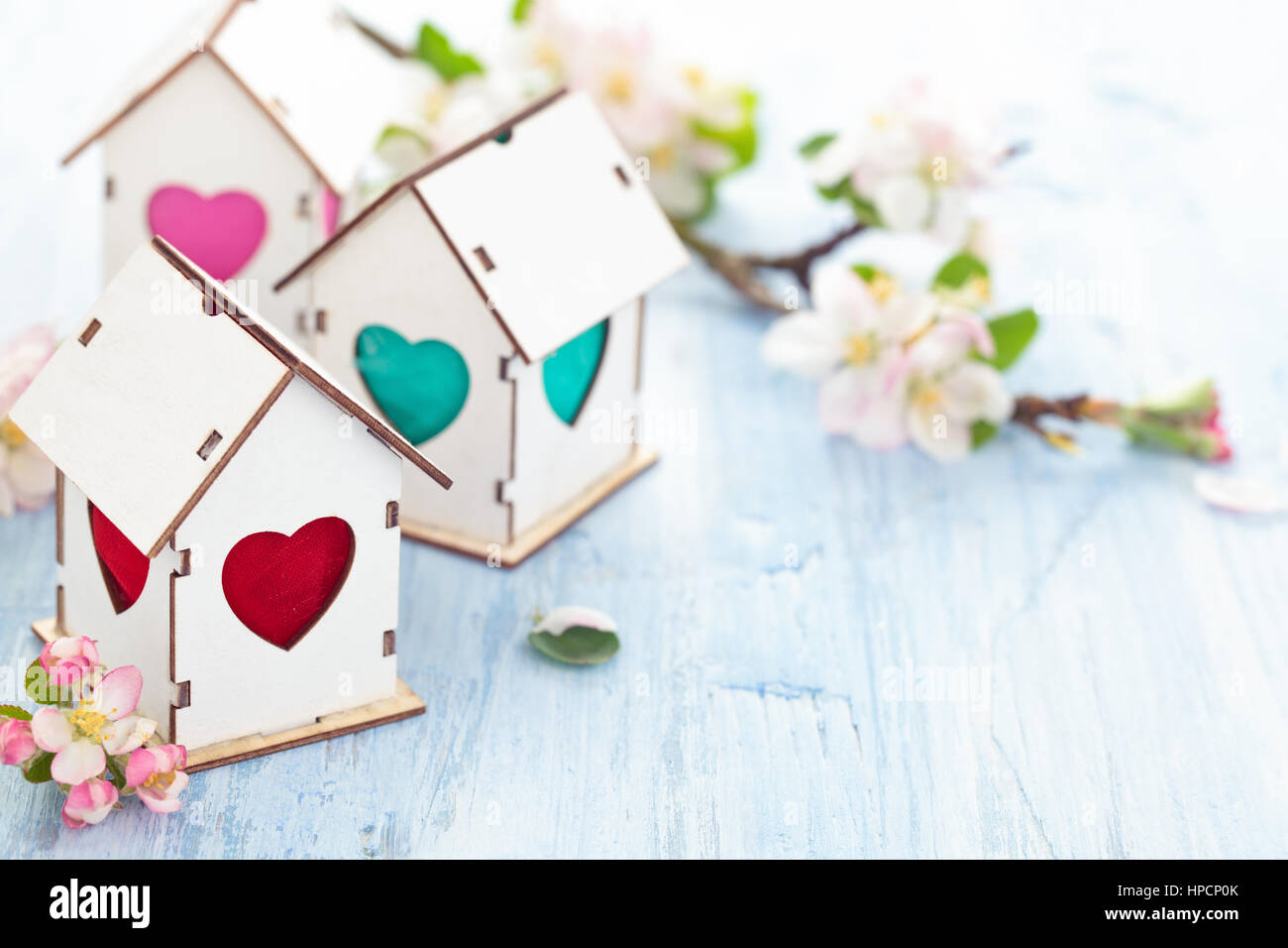 White Wood houses with colorful heart shaped windows Stock Photo - Alamy