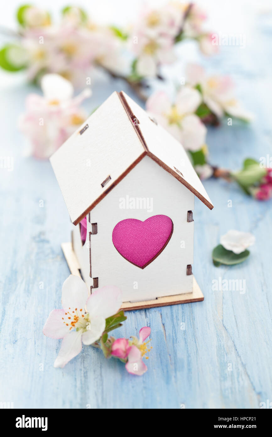 White Wood houses with colorful heart shaped windows Stock Photo - Alamy