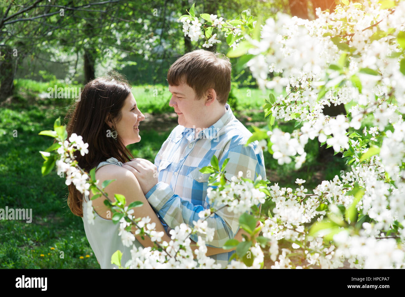 young loving couple walking in a spring garden Stock Photo - Alamy