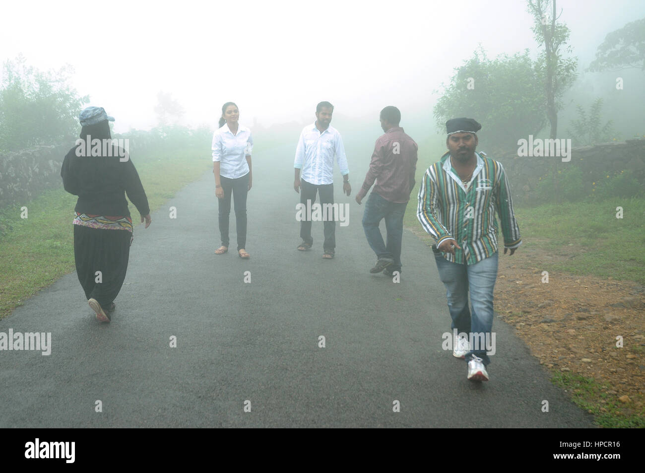 People standing and watching smoking forest road Stock Photo - Alamy