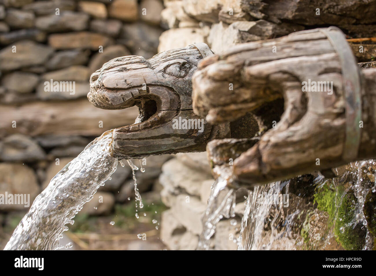 Wooden wall fountain in nepalese village in Annapurna Region, Nepal ...