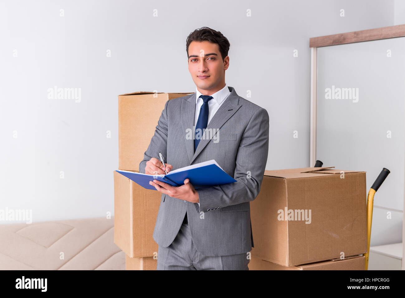 Man signing for the delivery of boxes Stock Photo - Alamy