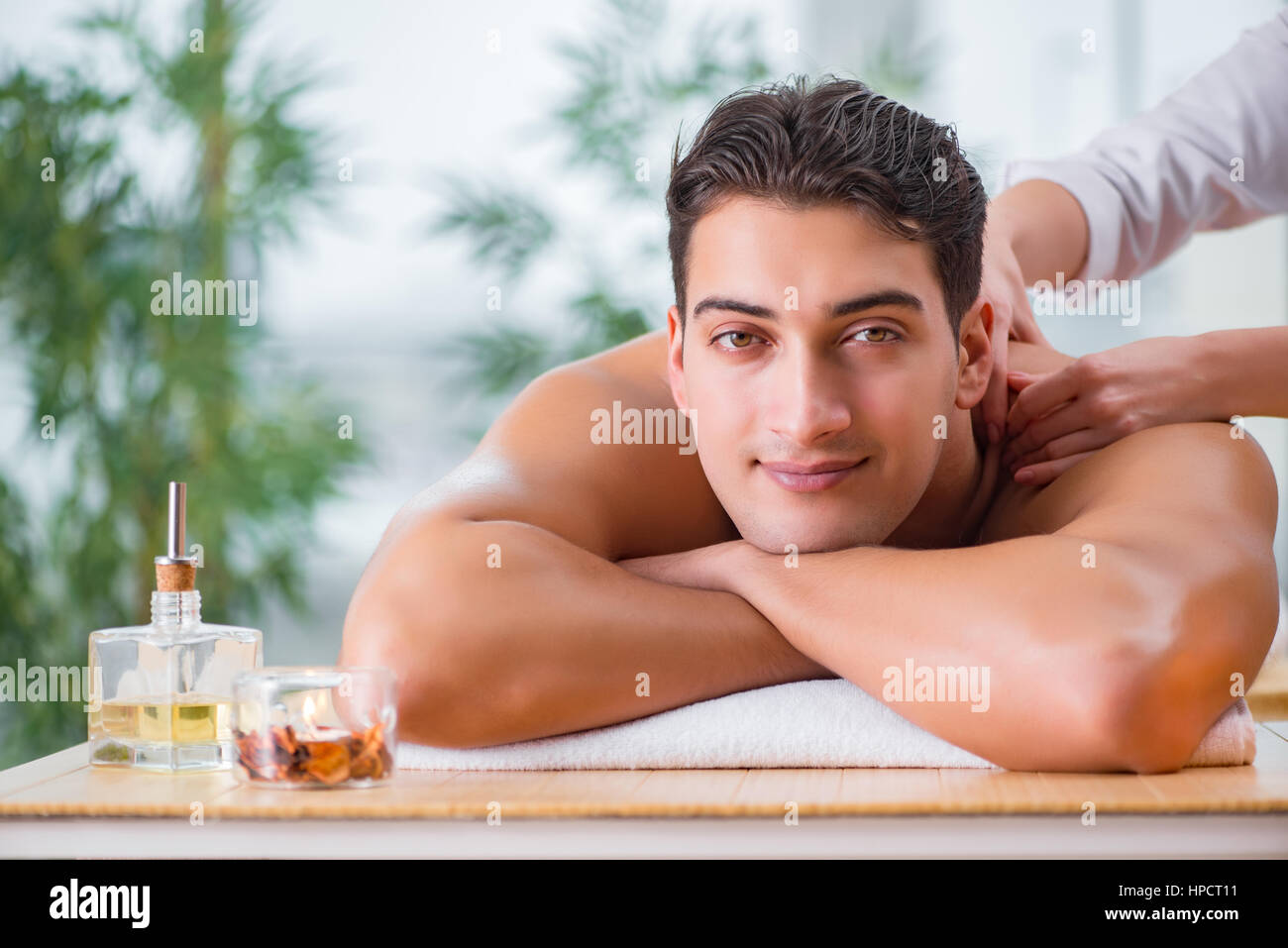 Handsome man during spa massaging session Stock Photo - Alamy