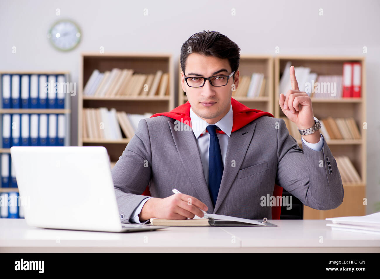 Superhero businessman working in the office Stock Photo - Alamy