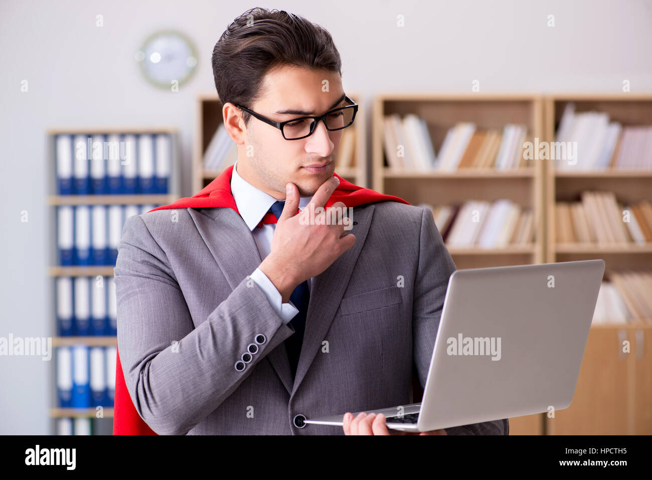 Superhero businessman working in the office Stock Photo - Alamy