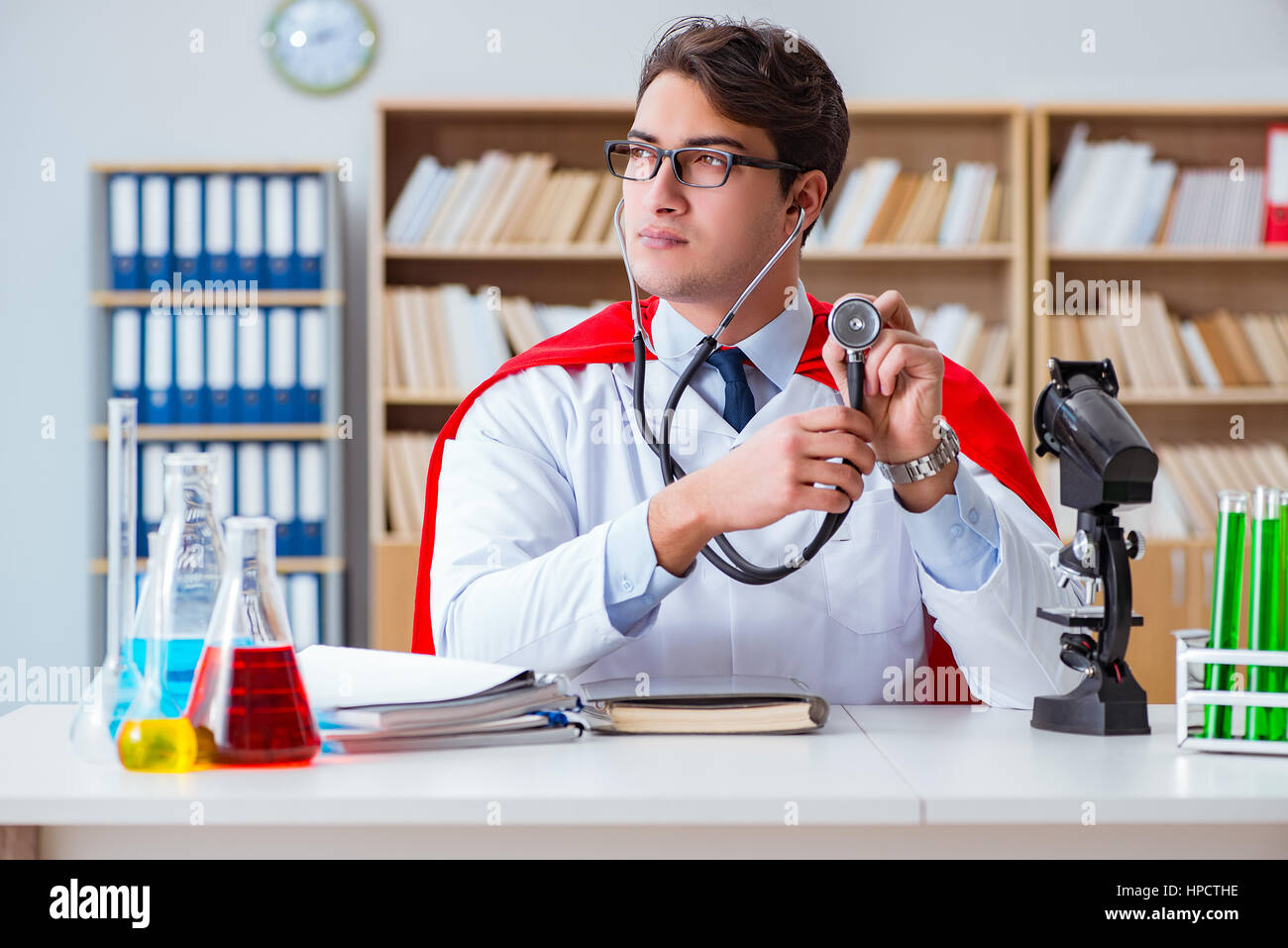 Superhero doctor working in the hospital lab Stock Photo - Alamy