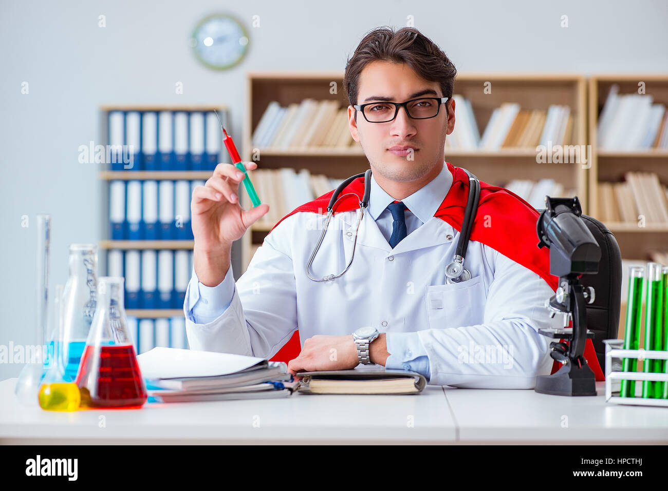 Superhero doctor working in the hospital lab Stock Photo - Alamy