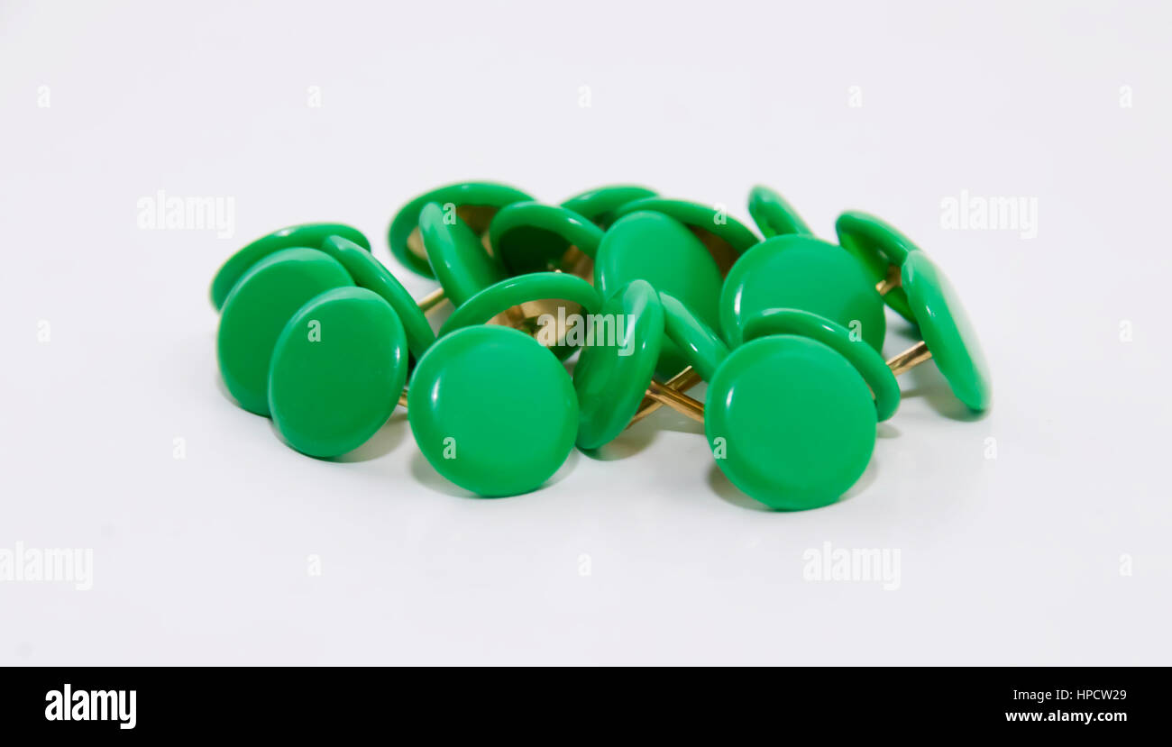 Green push pins on a white background Stock Photo - Alamy
