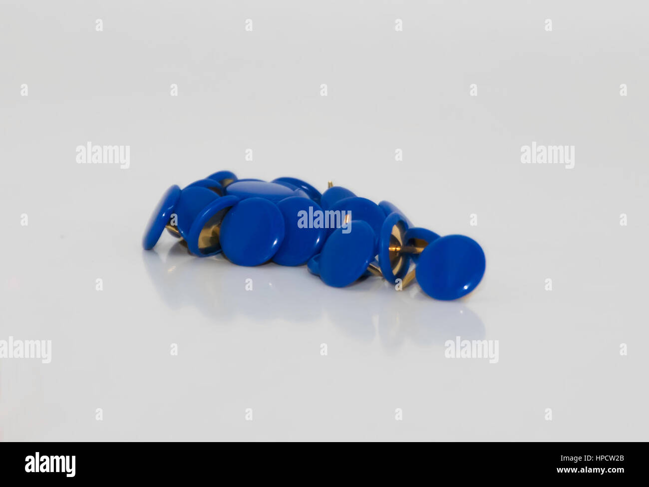 Blue push pins on a white background Stock Photo - Alamy