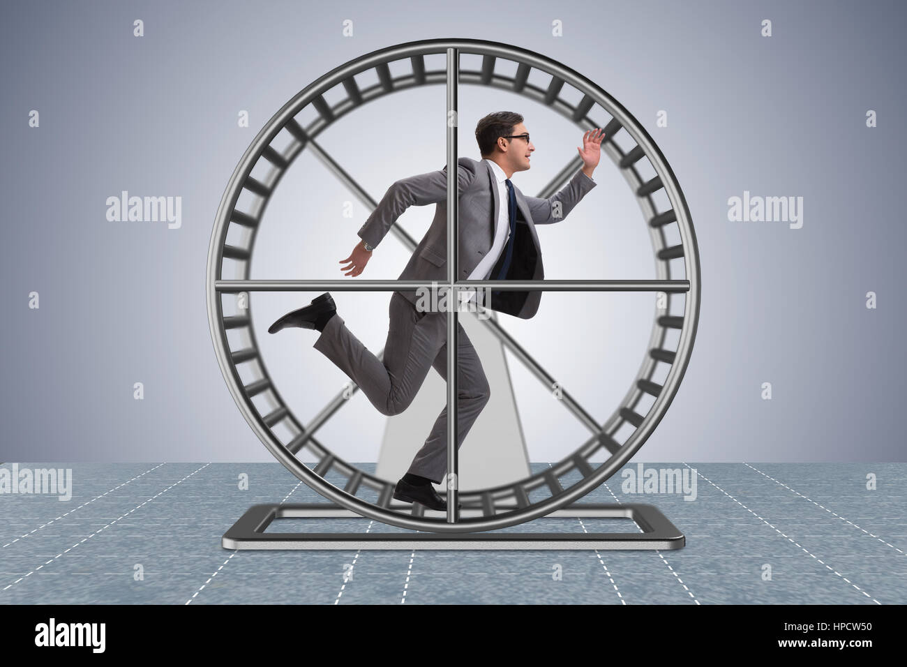 Businessman running on hamster wheel Stock Photo - Alamy