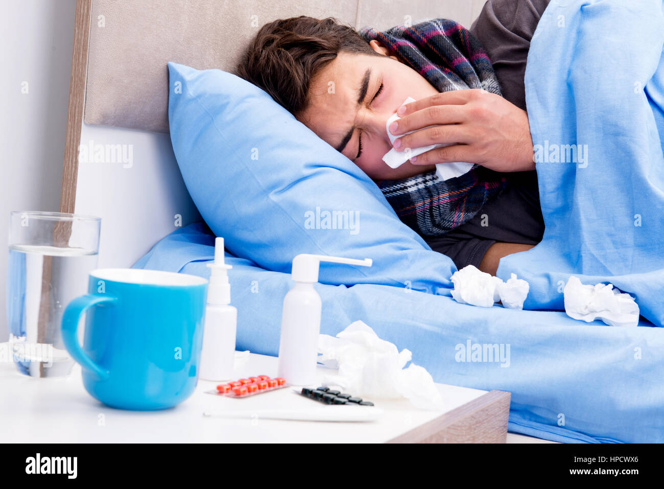 Sick ill man in the bed taking medicines and drugs Stock Photo - Alamy
