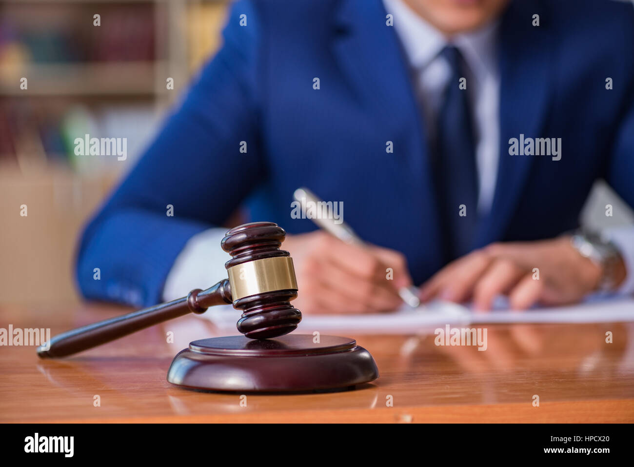 Handsome judge with gavel sitting in courtroom Stock Photo - Alamy
