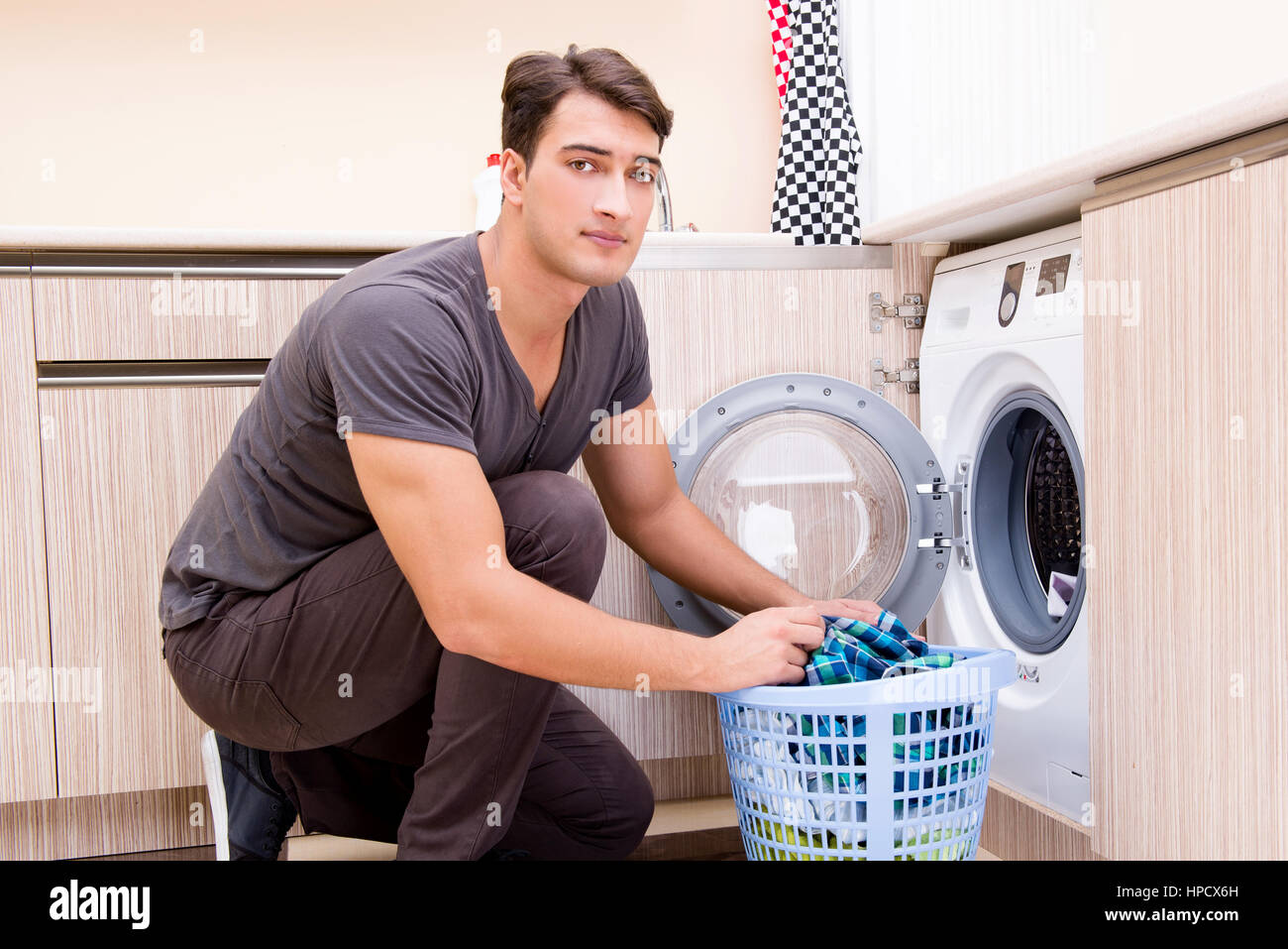 Young husband man doing laundry at home Stock Photo - Alamy