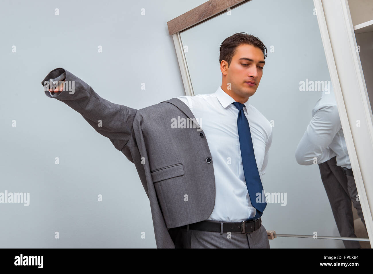 Businessman dressing up for work Stock Photo - Alamy