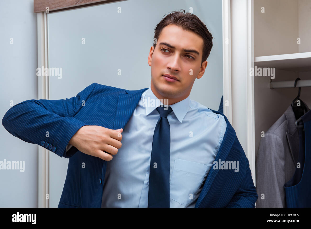 Businessman dressing up for work Stock Photo - Alamy