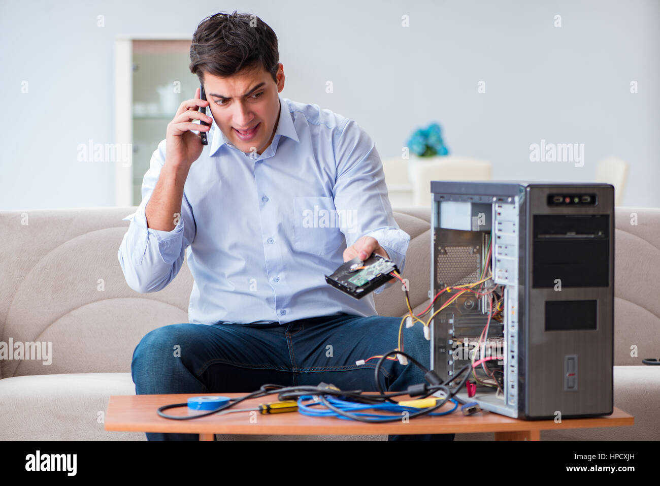 Angry customer trying to repair computer with phone support Stock Photo ...